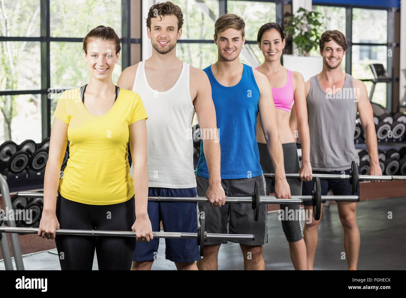 Fitness class lifting barbell Stock Photo - Alamy