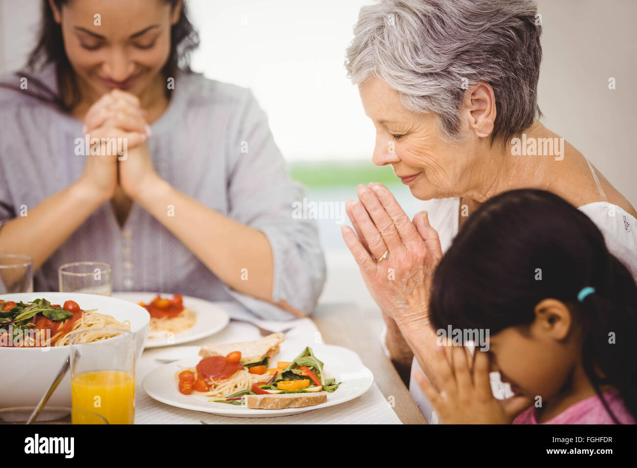 Family praying together before meal Stock Photo - Alamy