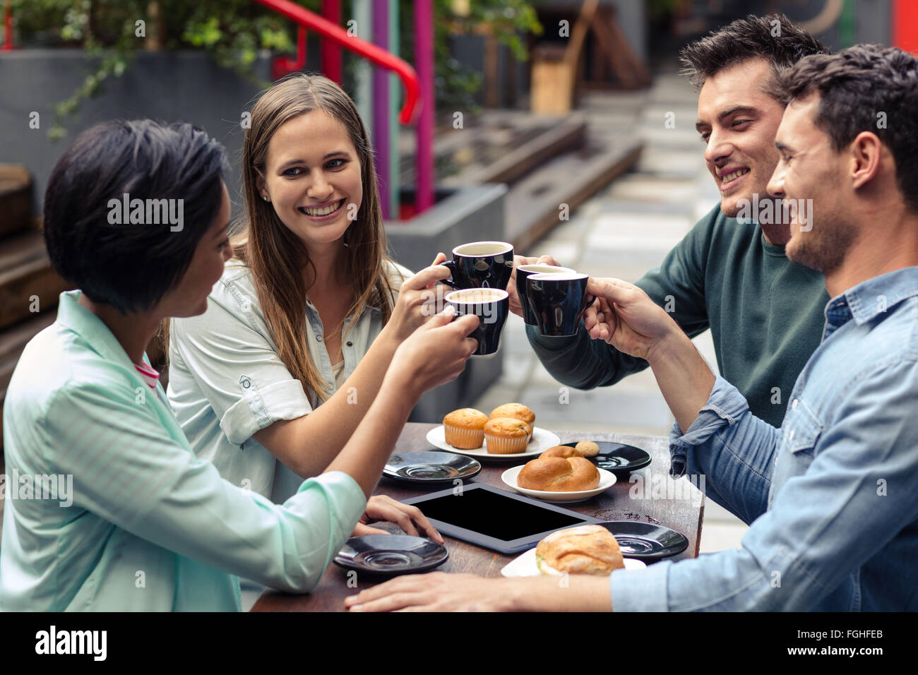 Happy friends having coffee together Stock Photo - Alamy