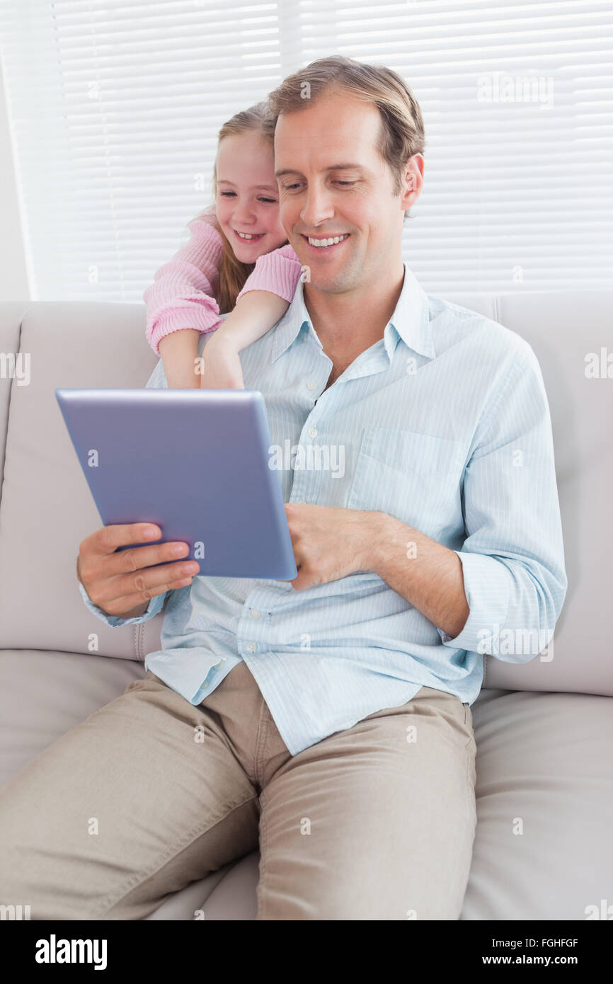 Casual father and daughter using tablet on the couch Stock Photo - Alamy