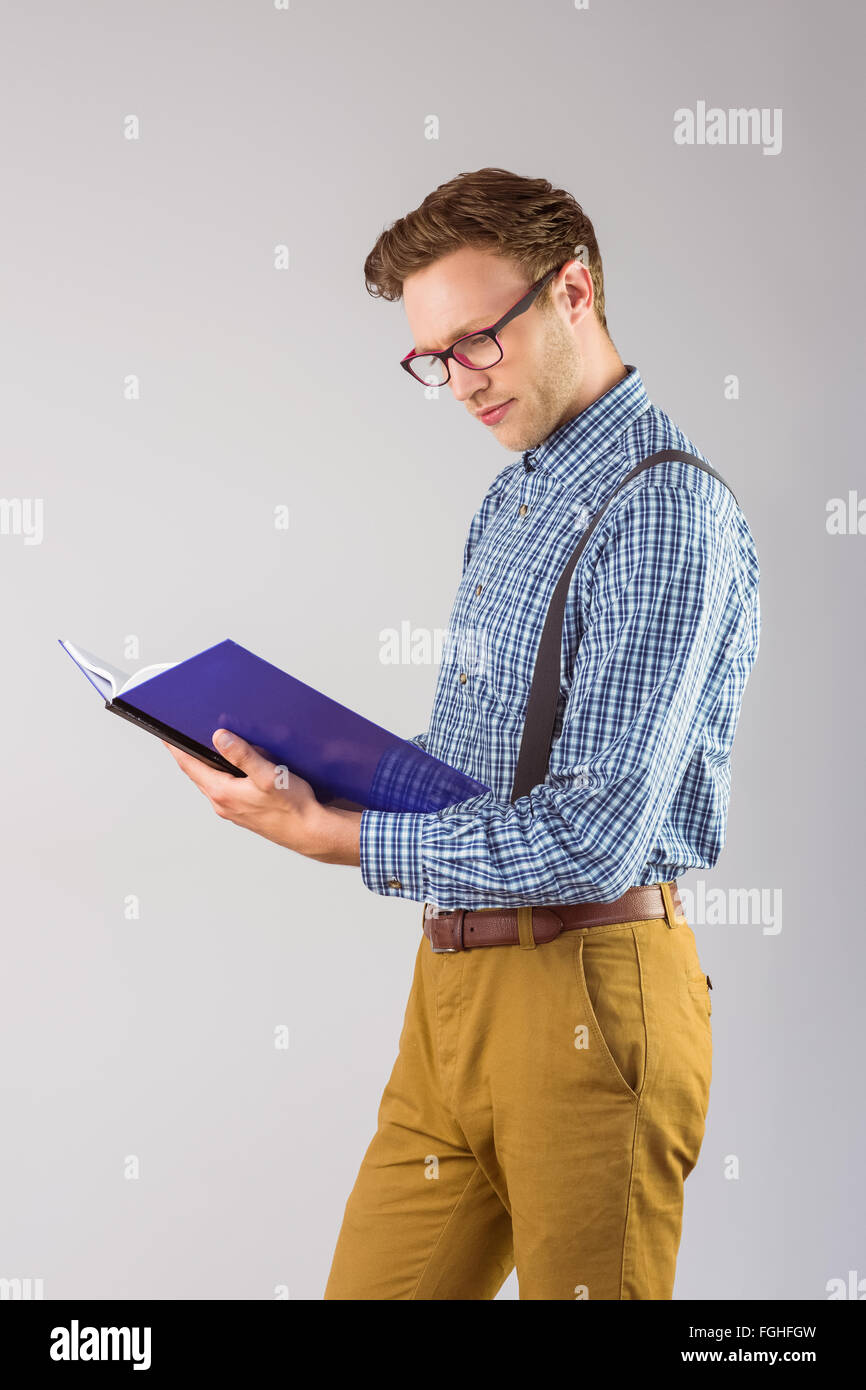 Geeky student reading a book Stock Photo - Alamy
