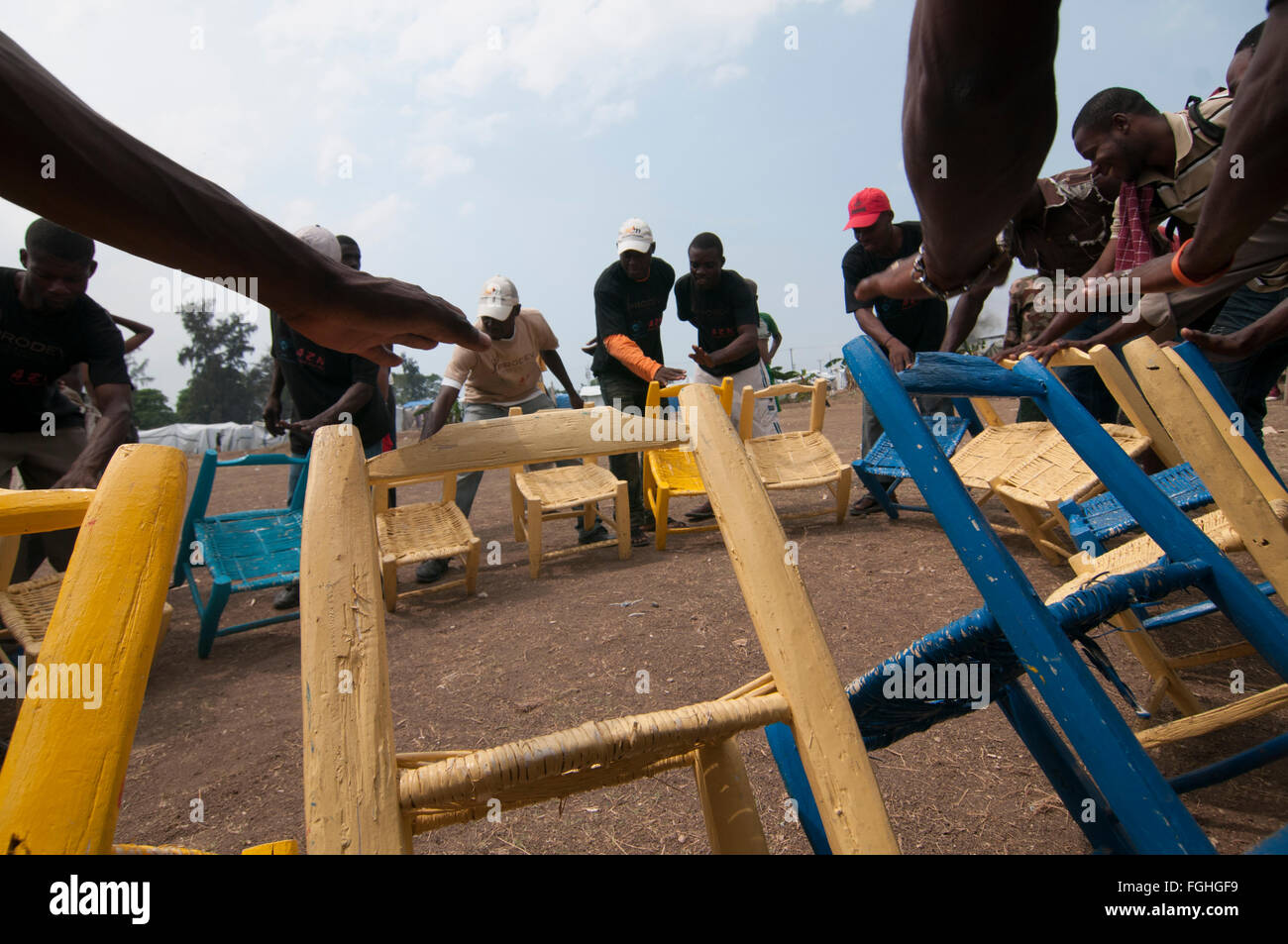 A group of men playing with changing chairs game at a temporary ...