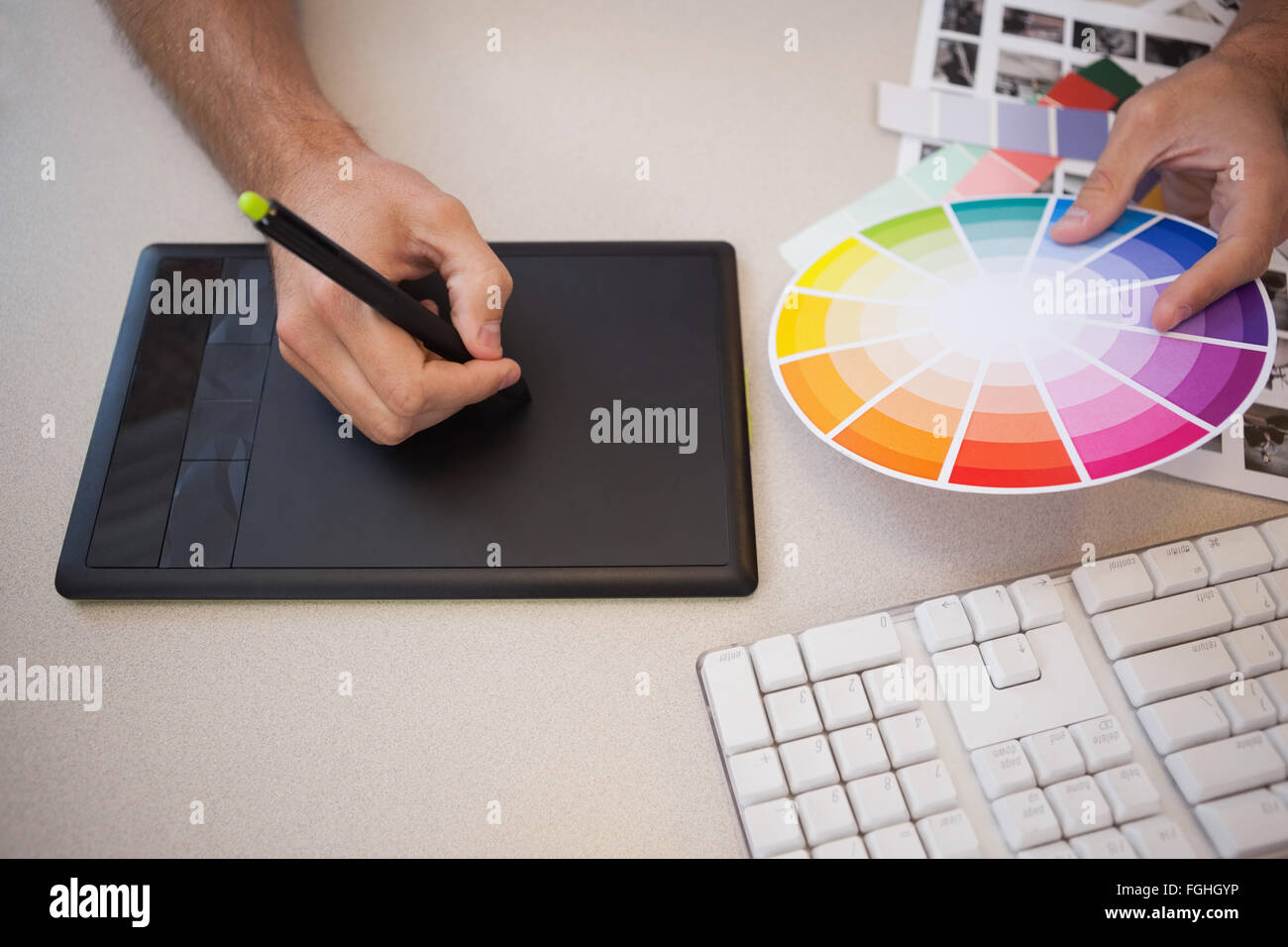Designer using graphics tablet and colour wheel Stock Photo - Alamy