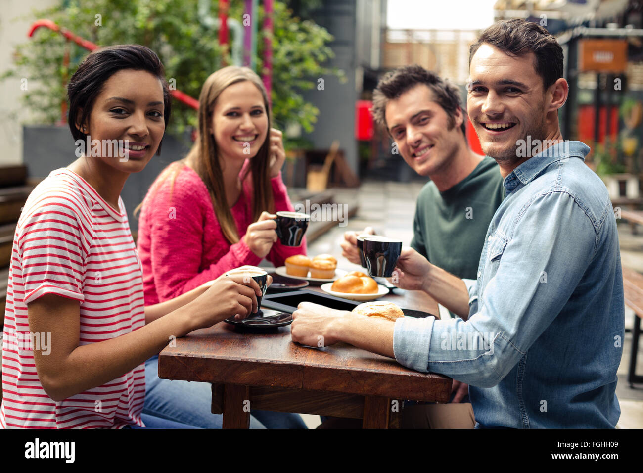 Happy friends having coffee together Stock Photo - Alamy