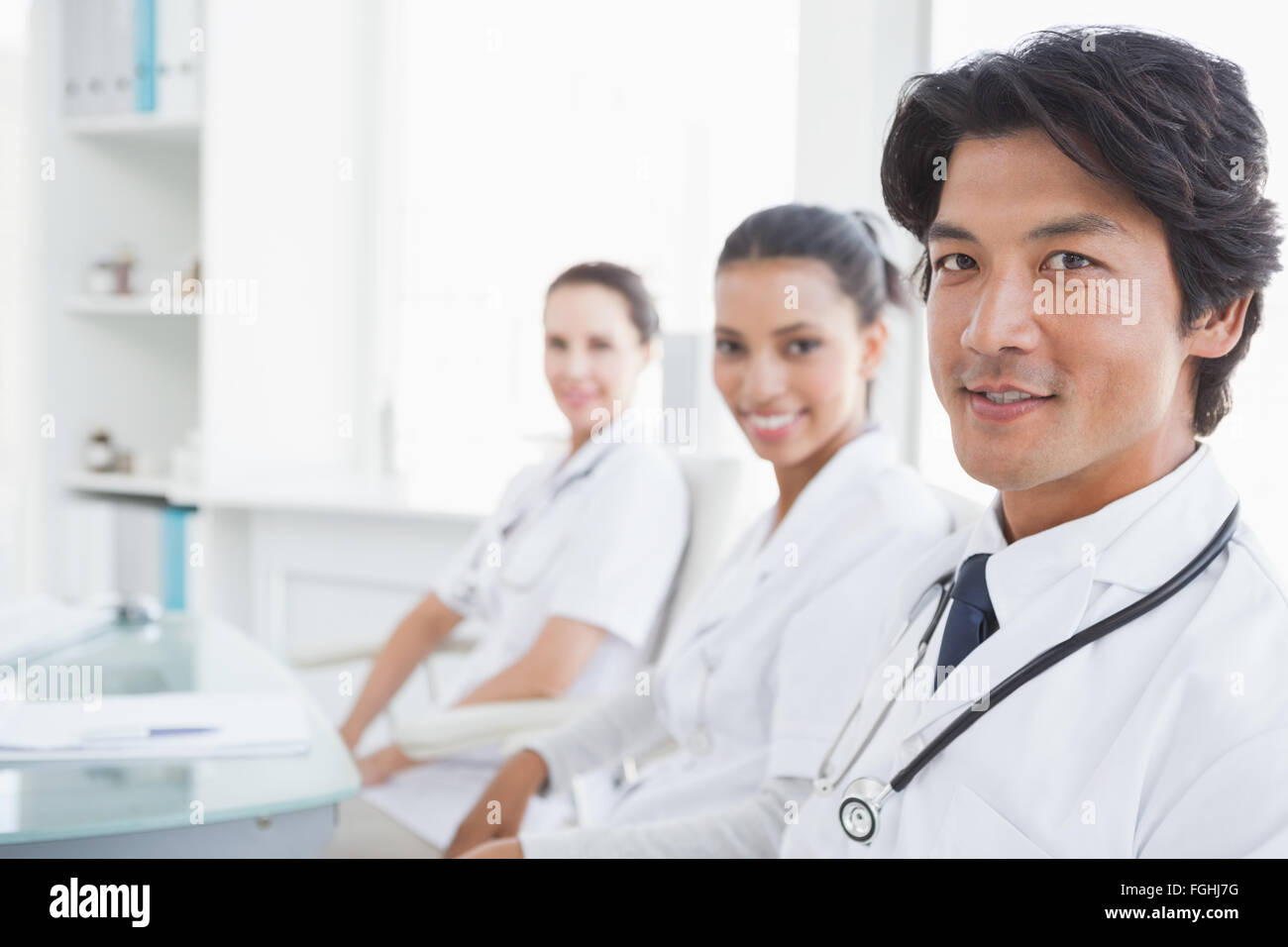 Smiling doctors sitting beside each other Stock Photo - Alamy