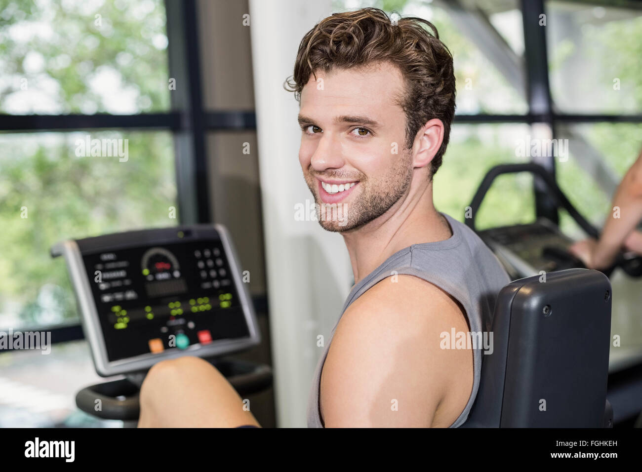 Fit man doing exercise bike Stock Photo - Alamy