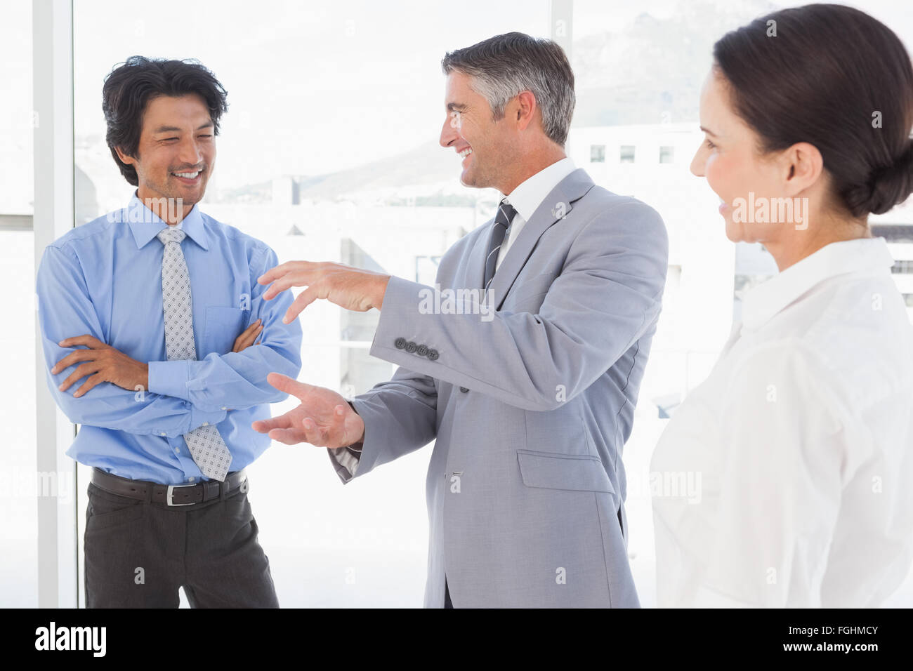 Happy employees having a discussion Stock Photo - Alamy