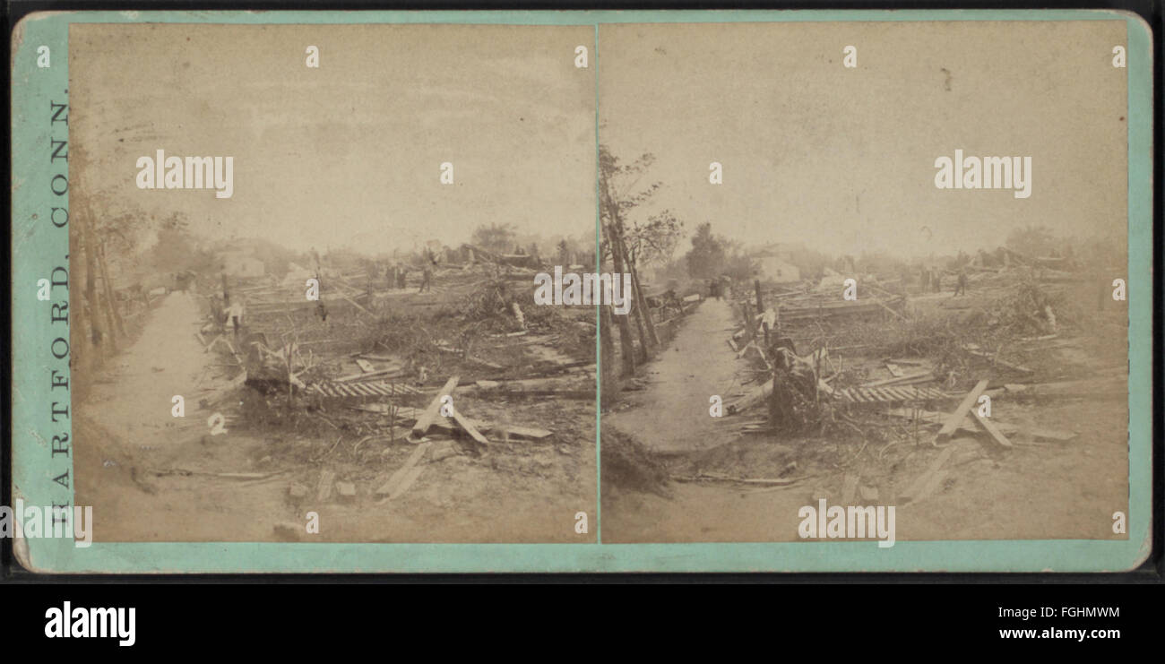 A photograph by Daniel S. Camp showing the debris of collapsed houses ...