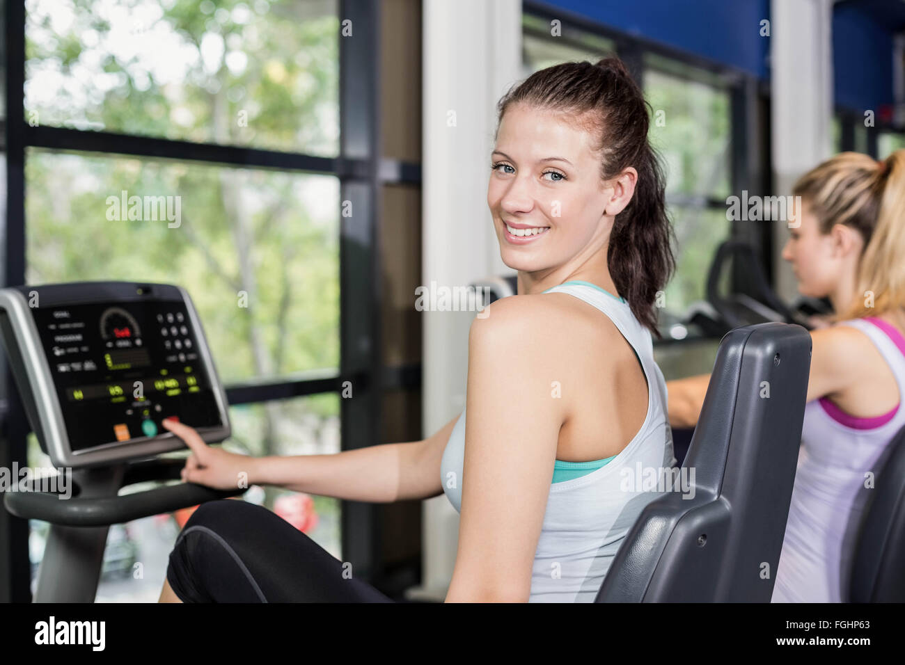 Fit woman doing exercise bike Stock Photo - Alamy