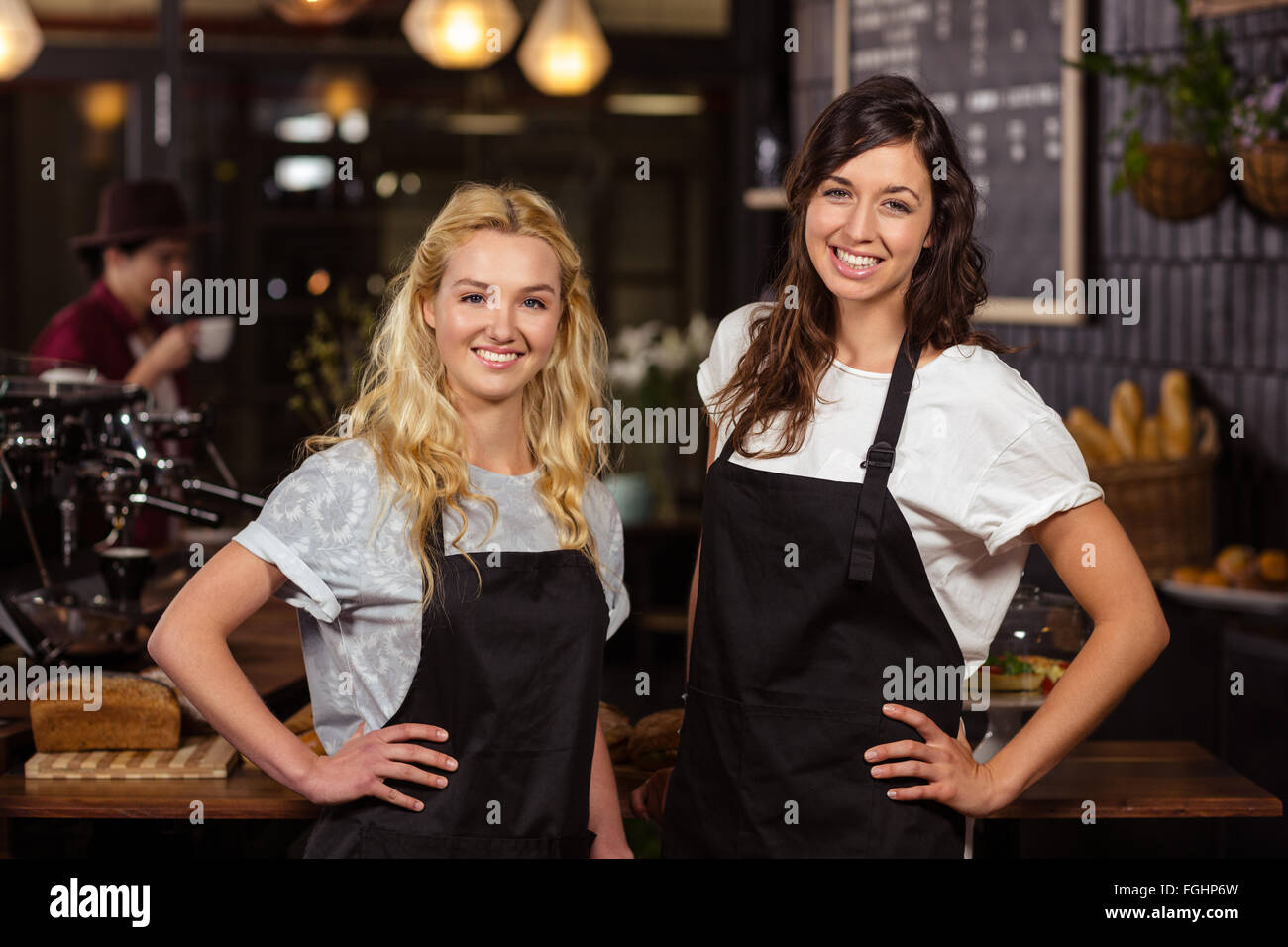Pretty waitresses posing in front of the counter Stock Photo - Alamy