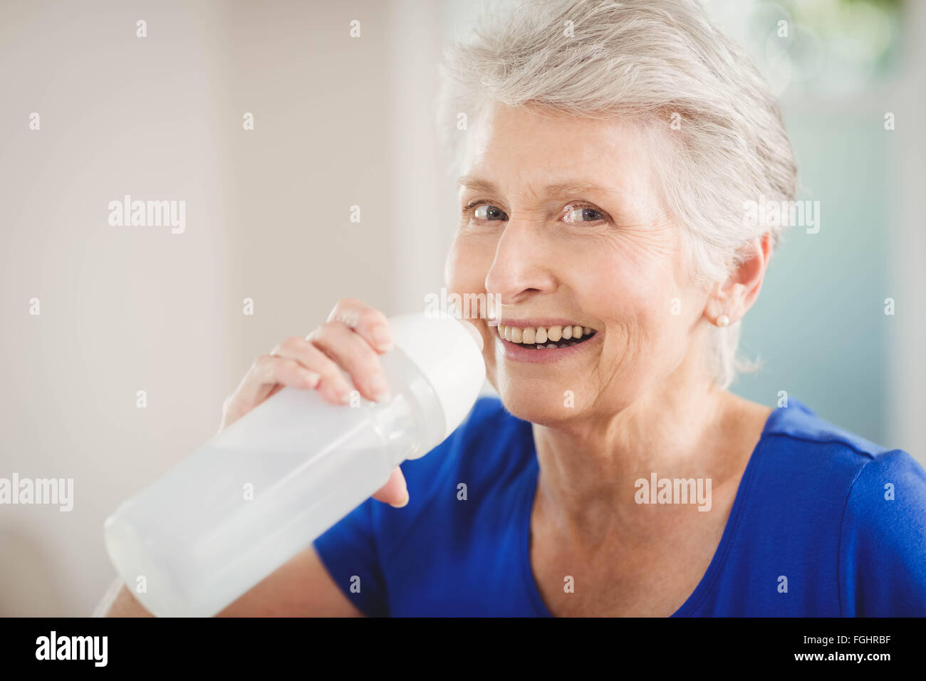 Happy senior woman drinking water Stock Photo - Alamy