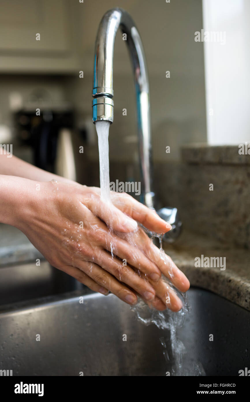 Pretty woman washing her hands Stock Photo - Alamy