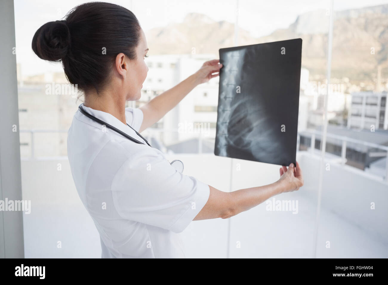 Doctor checking a patients x ray Stock Photo - Alamy
