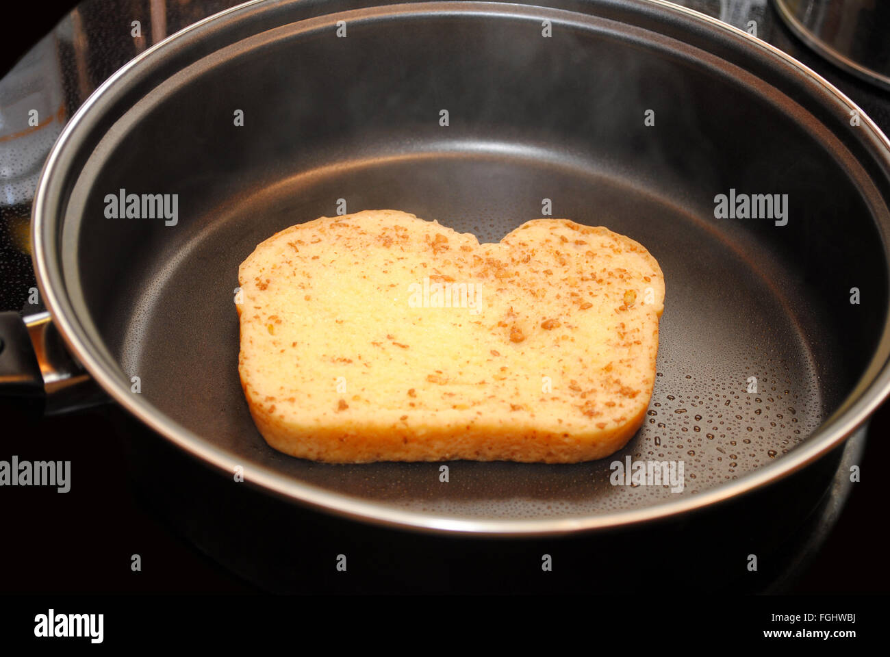A Slice of Raw French Toast Cooking in a Fry Pan Stock Photo - Alamy