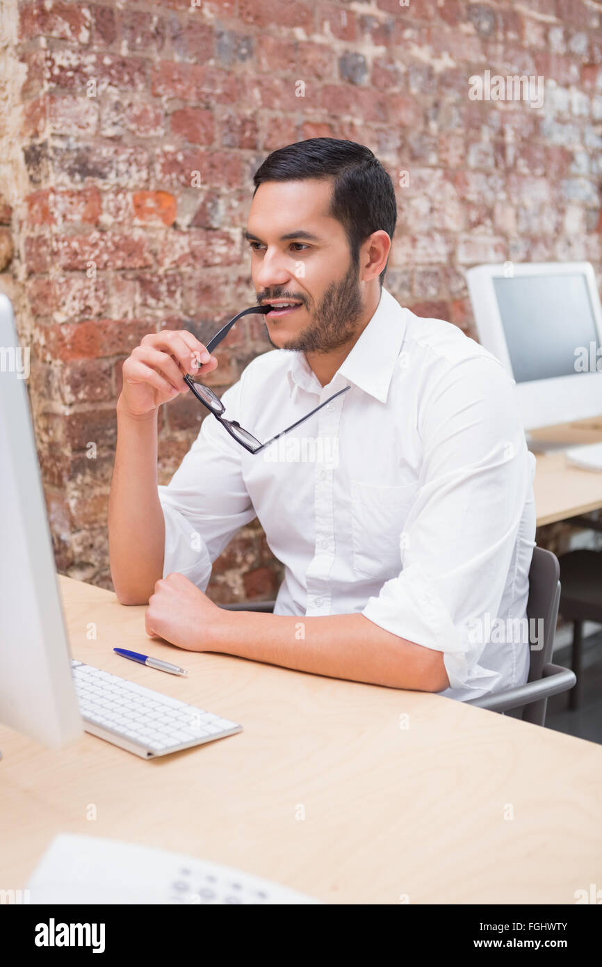 Businessman using computer at desk Stock Photo - Alamy