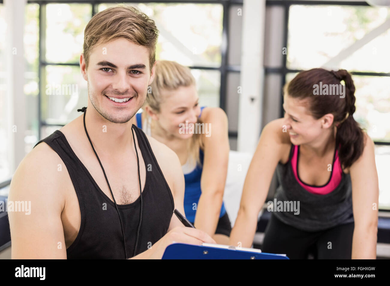 Fit group of people using exercise bike together Stock Photo - Alamy