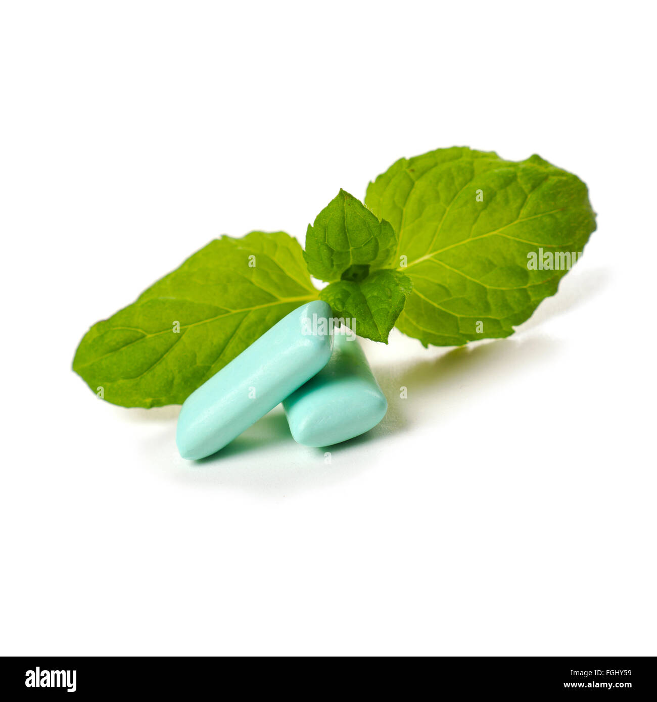 Two chewing gum with a leaf of mint on a white background Stock Photo ...