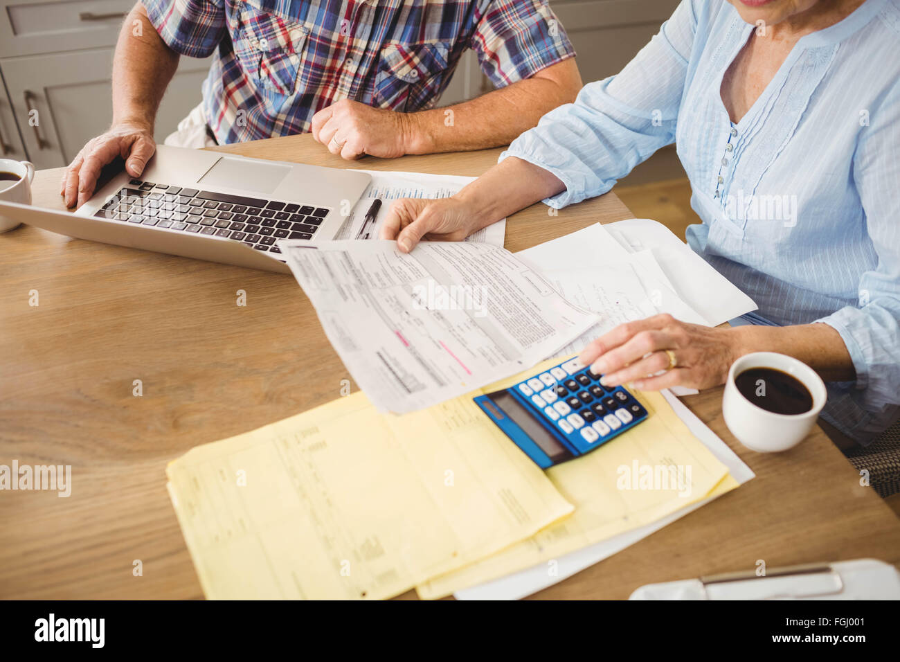 Senior couple checking their bills Stock Photo - Alamy