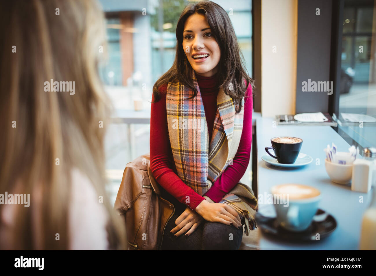 Pretty friends chatting over coffee Stock Photo - Alamy
