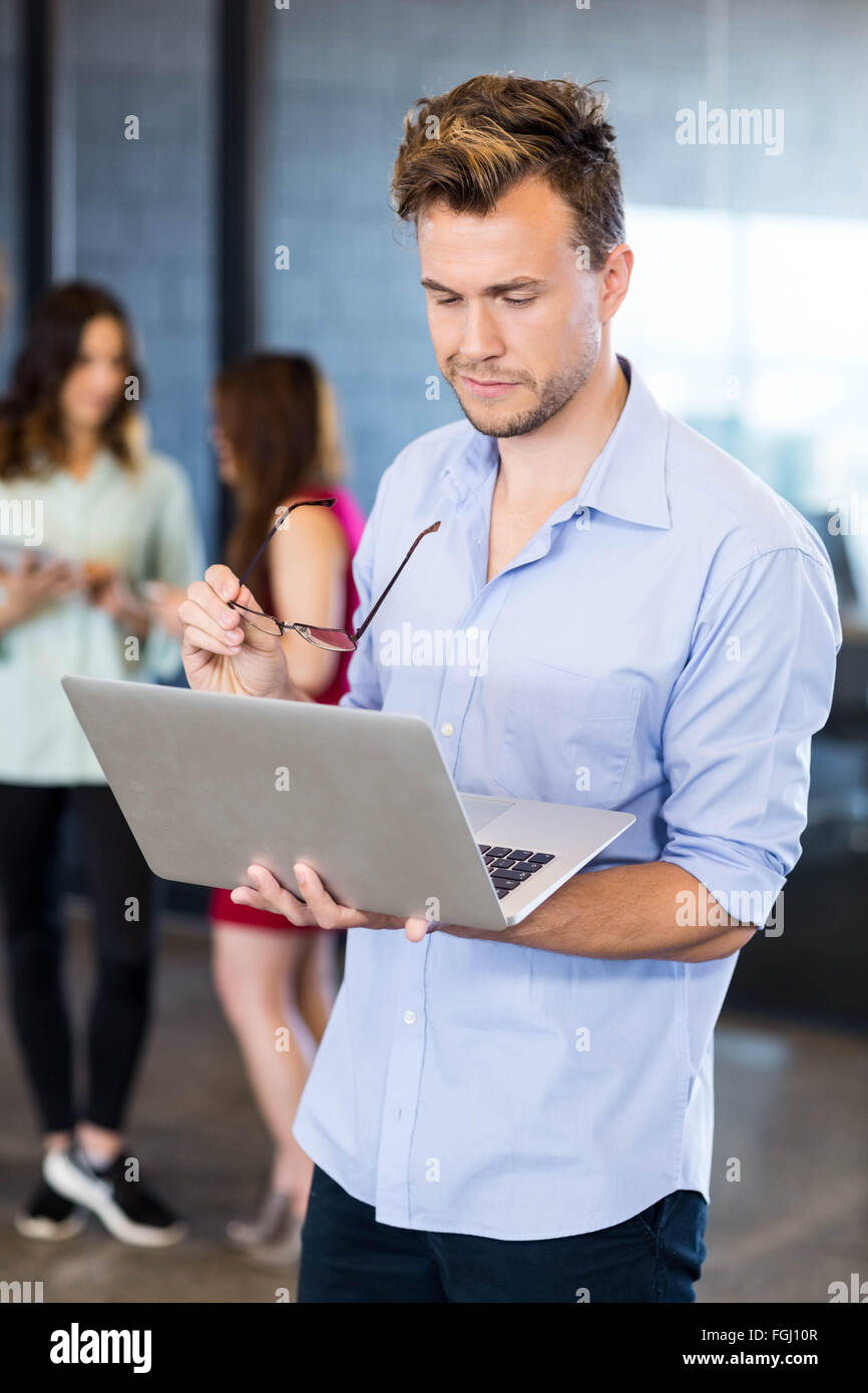 Man using a laptop in office Stock Photo - Alamy