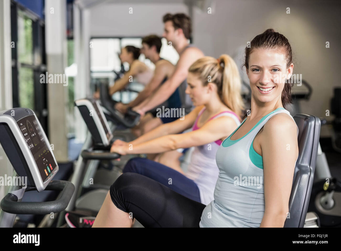 Fit people doing exercise bike Stock Photo - Alamy