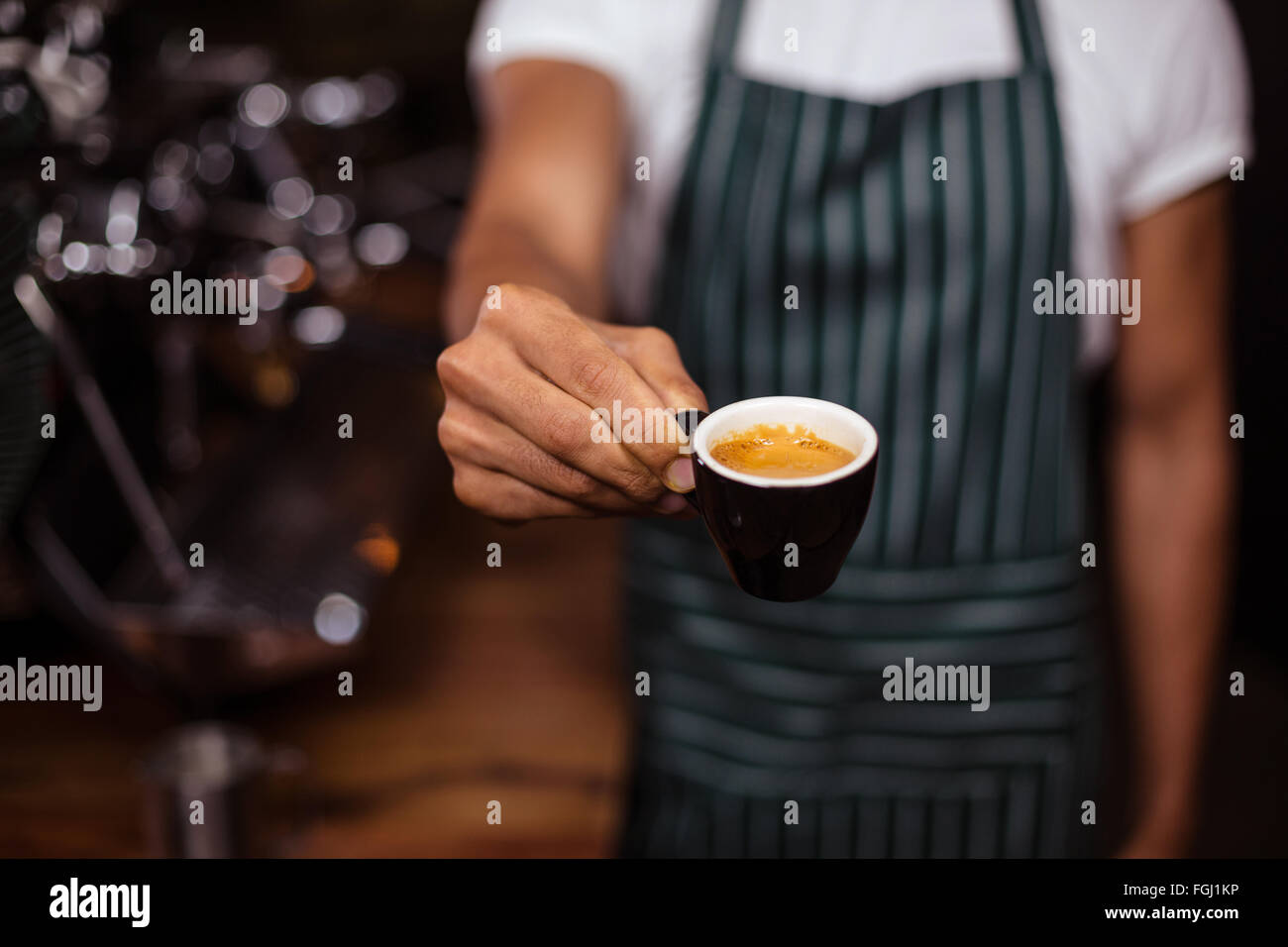 Barista offering an espresso Stock Photo - Alamy