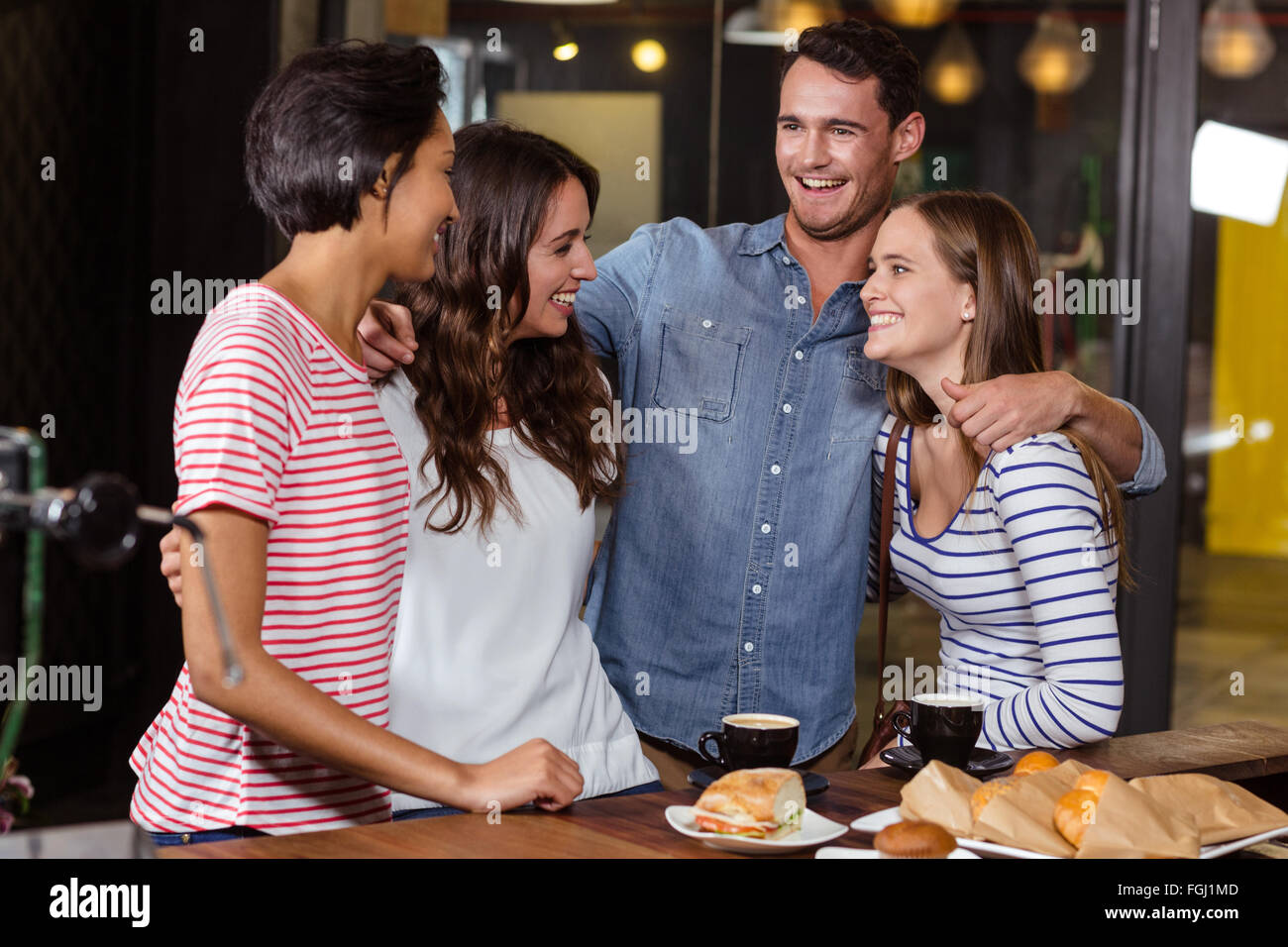 Smiling friends having coffee Stock Photo - Alamy