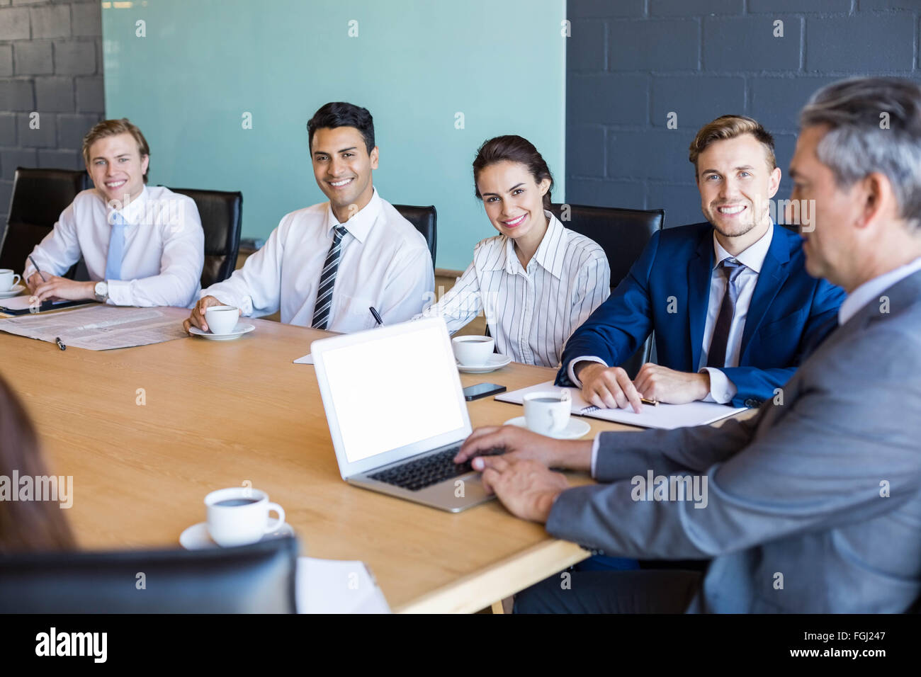 Businesspeople sitting in conference room during a meeting Stock Photo ...