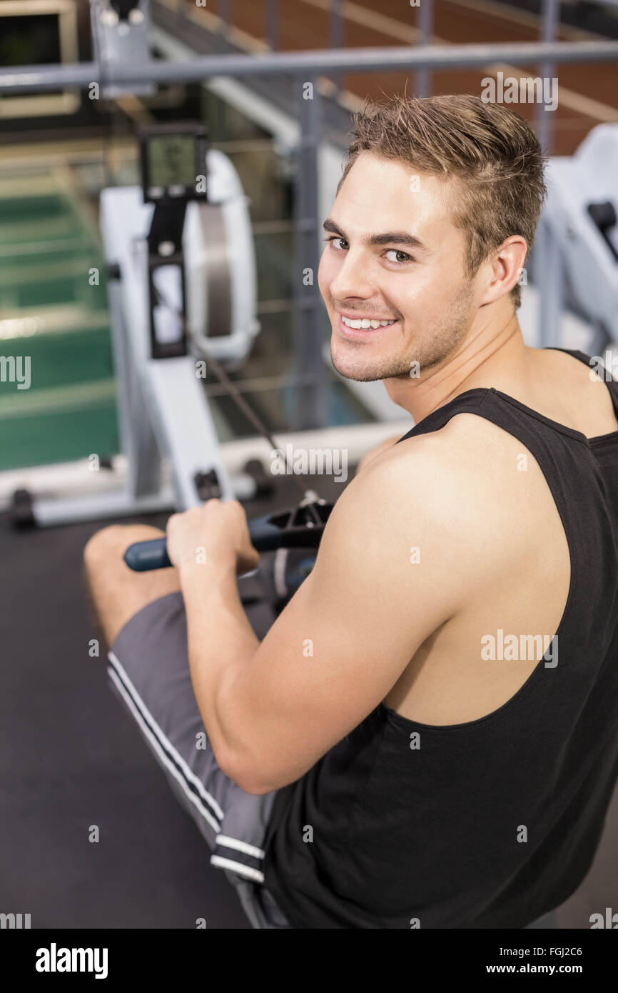 Fit man on drawing machine Stock Photo - Alamy