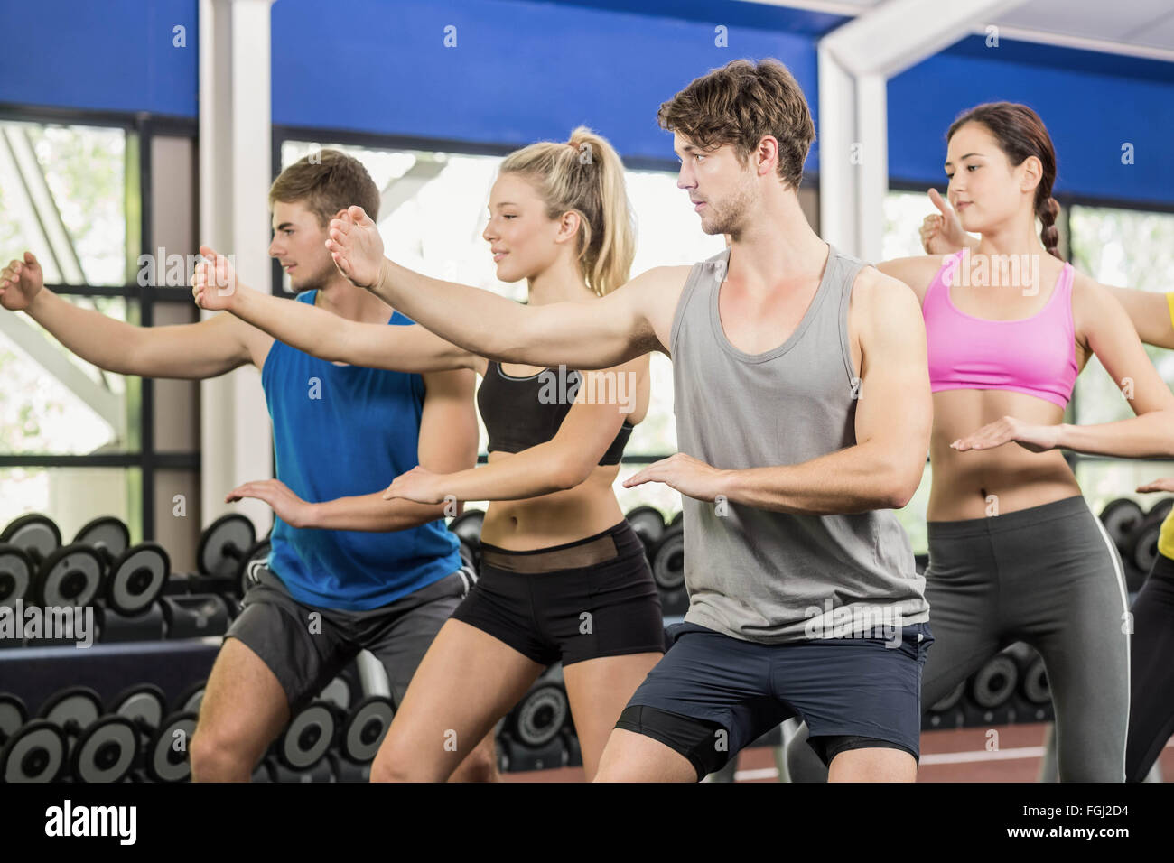 Athletic men and women working out Stock Photo - Alamy
