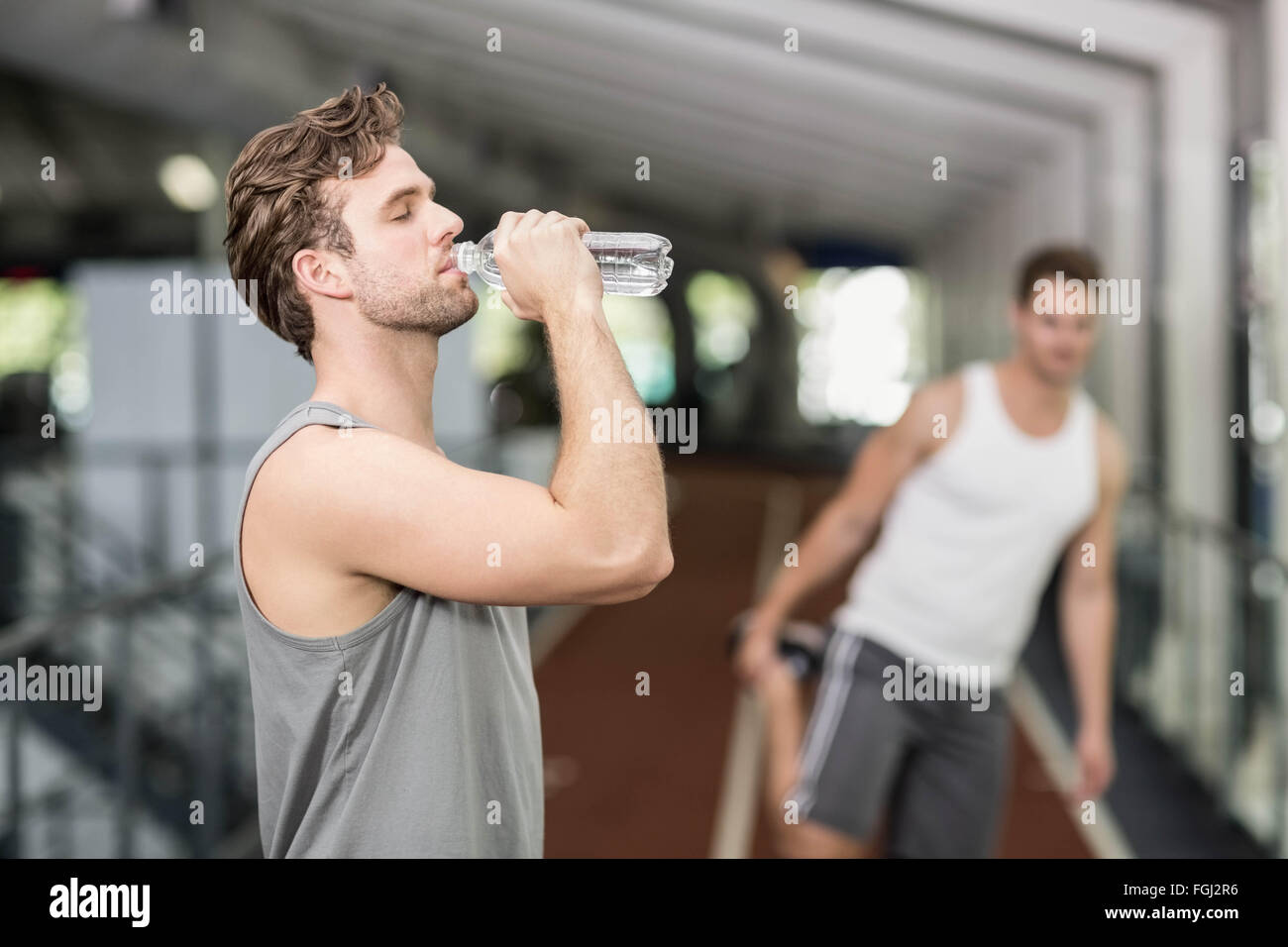 Fit man drinking water Stock Photo - Alamy