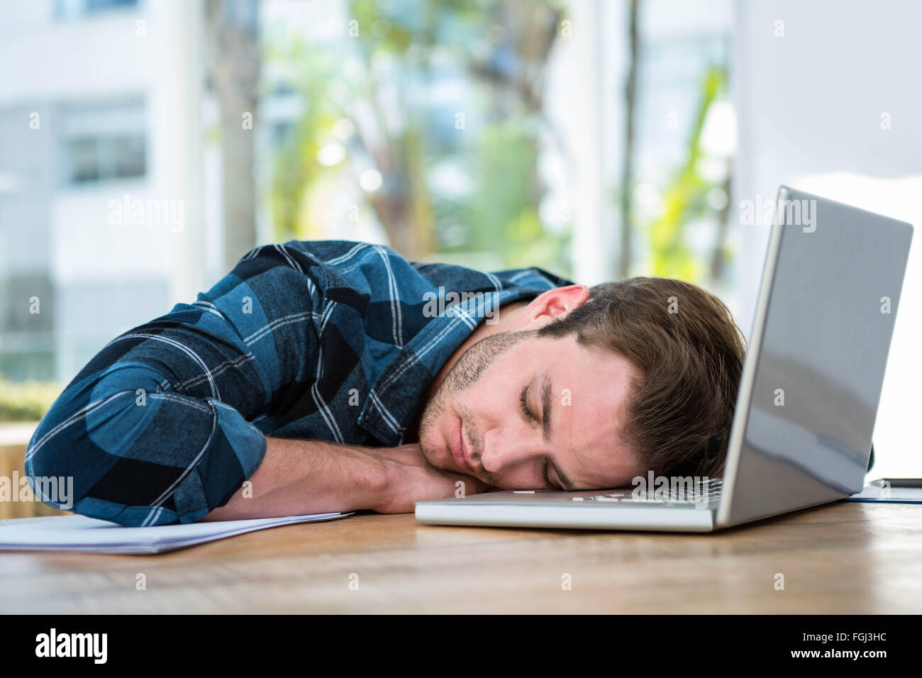 Handsome man sleeping on laptop Stock Photo - Alamy
