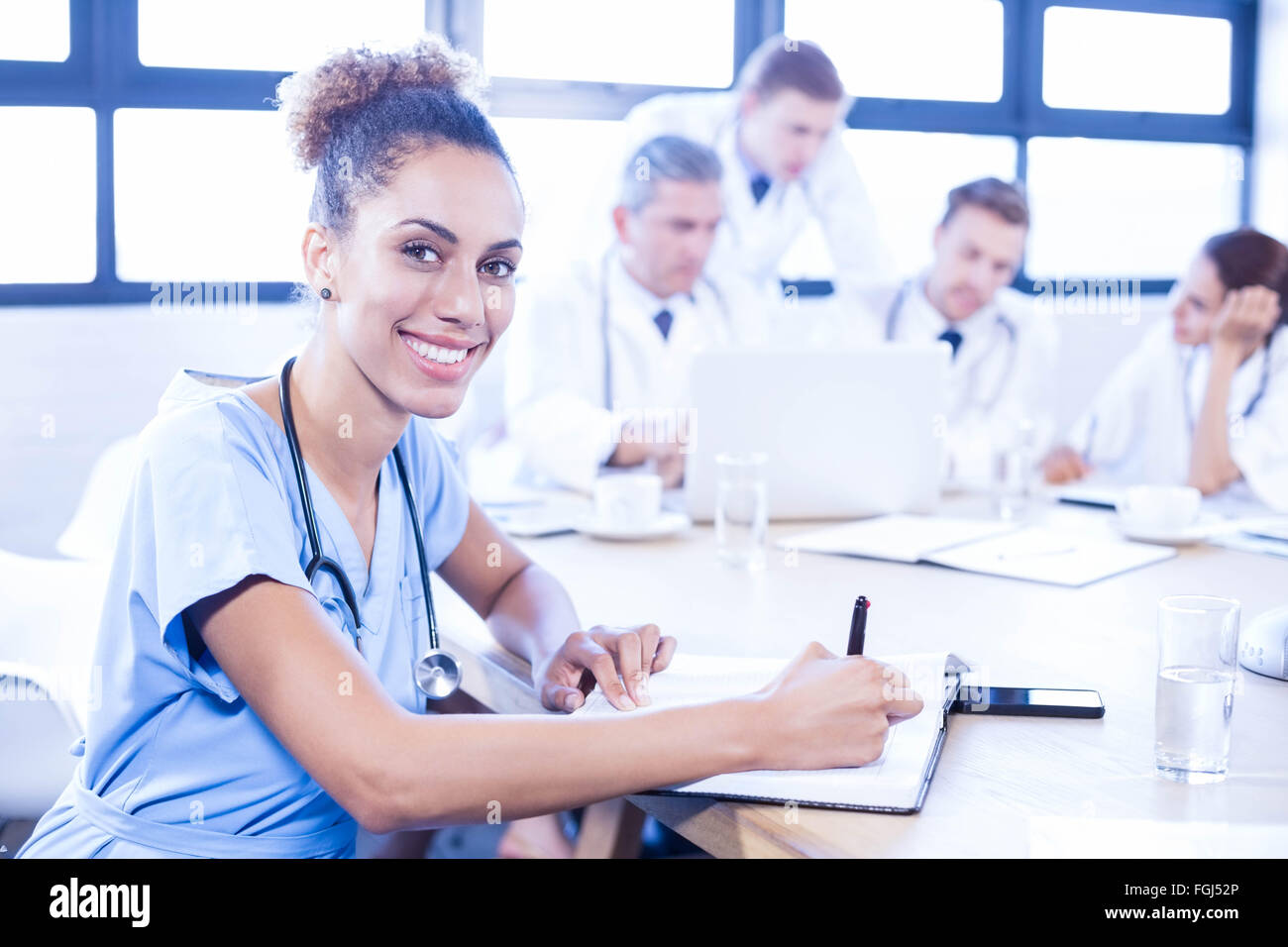 Portrait of female doctors writing on clipboard Stock Photo - Alamy