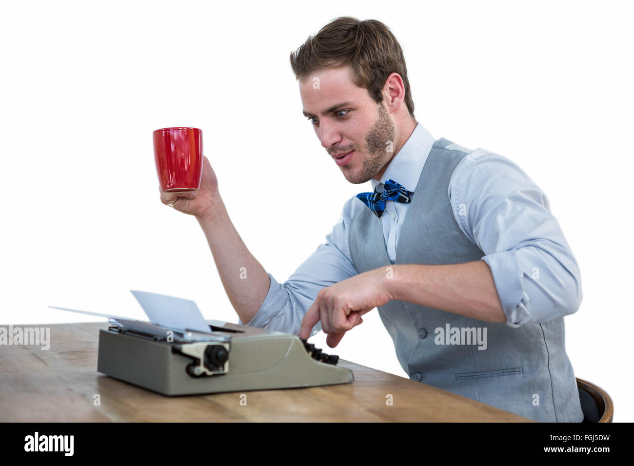 Handsome man using old fashioned typewriter Stock Photo - Alamy