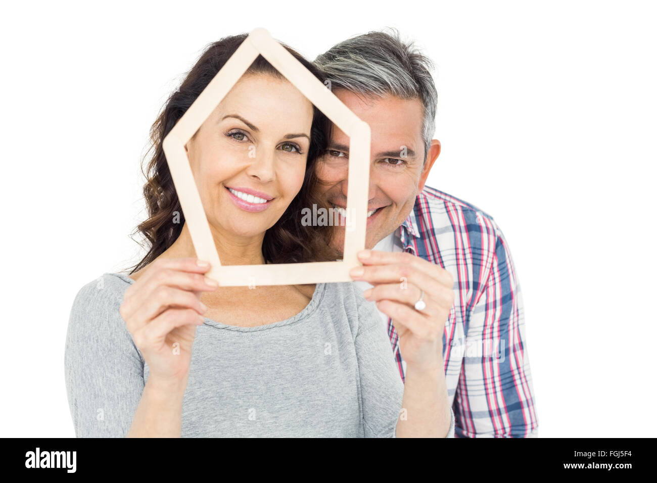 Couple holding house shape Stock Photo - Alamy