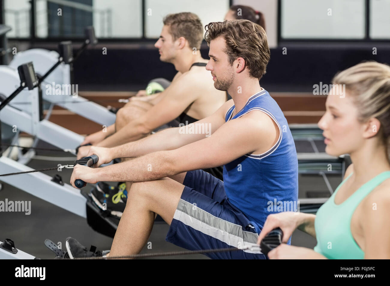 Fit people on drawing machine Stock Photo - Alamy