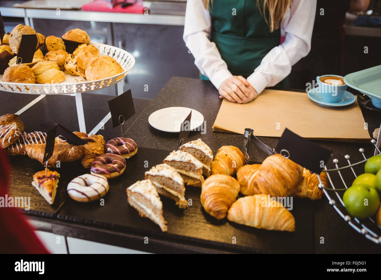 Woman standing behind counter hi-res stock photography and images - Alamy