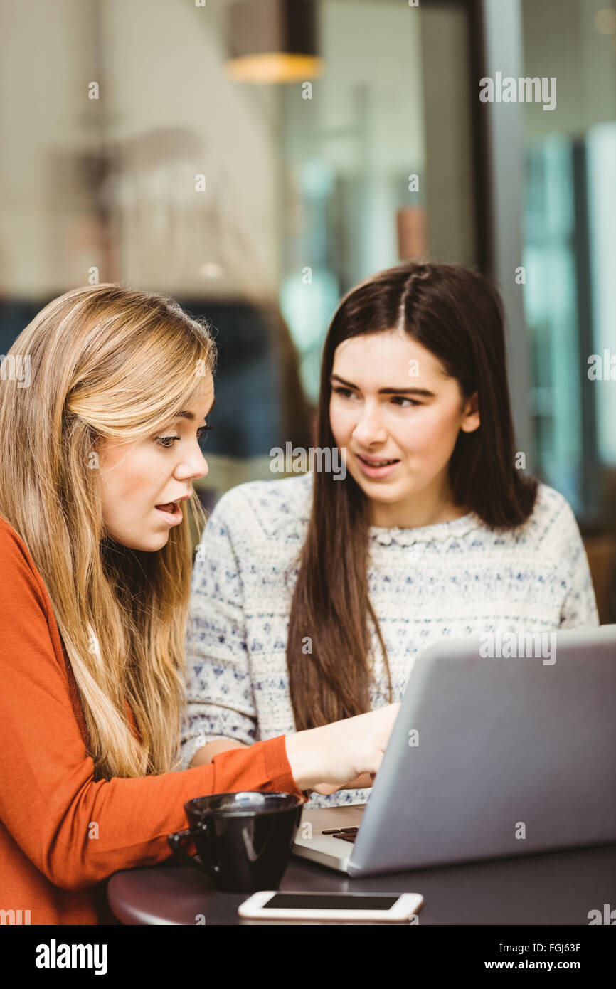 Friends using laptop together Stock Photo - Alamy