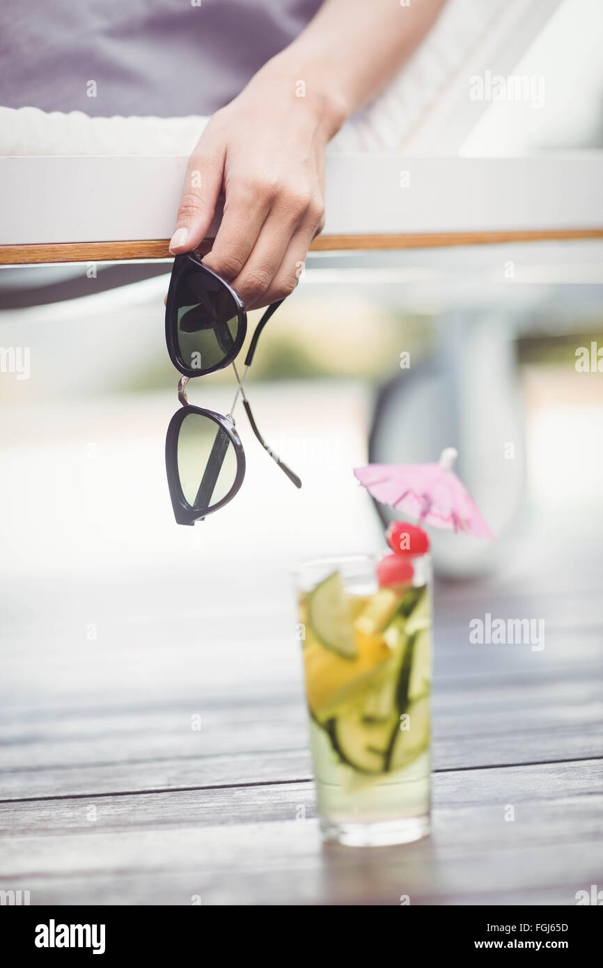 Close-up of womans hand holding sunglasses Stock Photo - Alamy