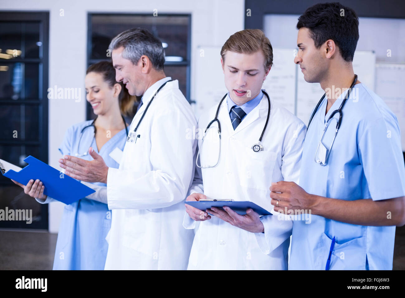 Medical team discussing the medical report together Stock Photo - Alamy