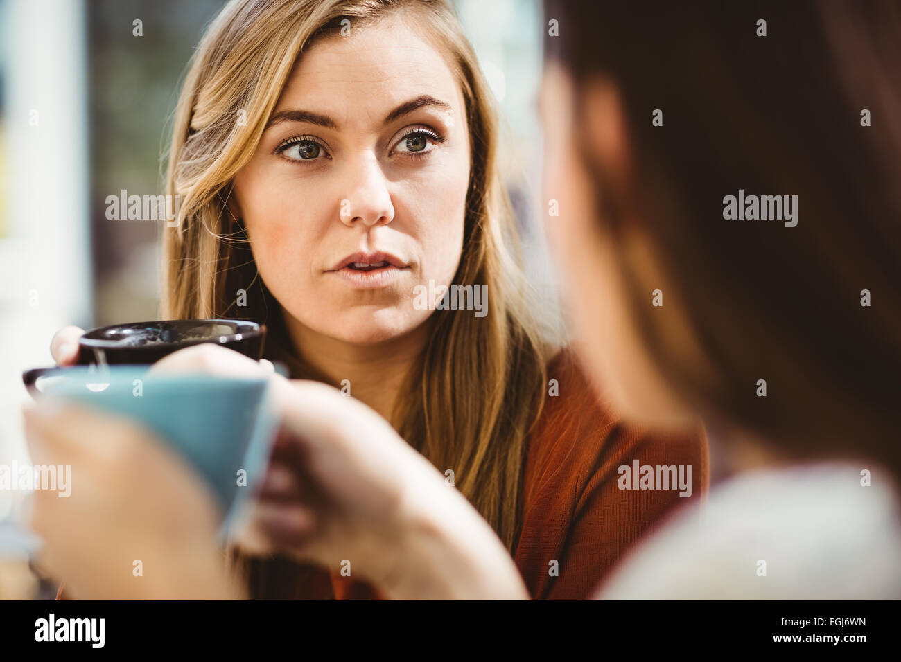 Friends chatting over coffee Stock Photo - Alamy