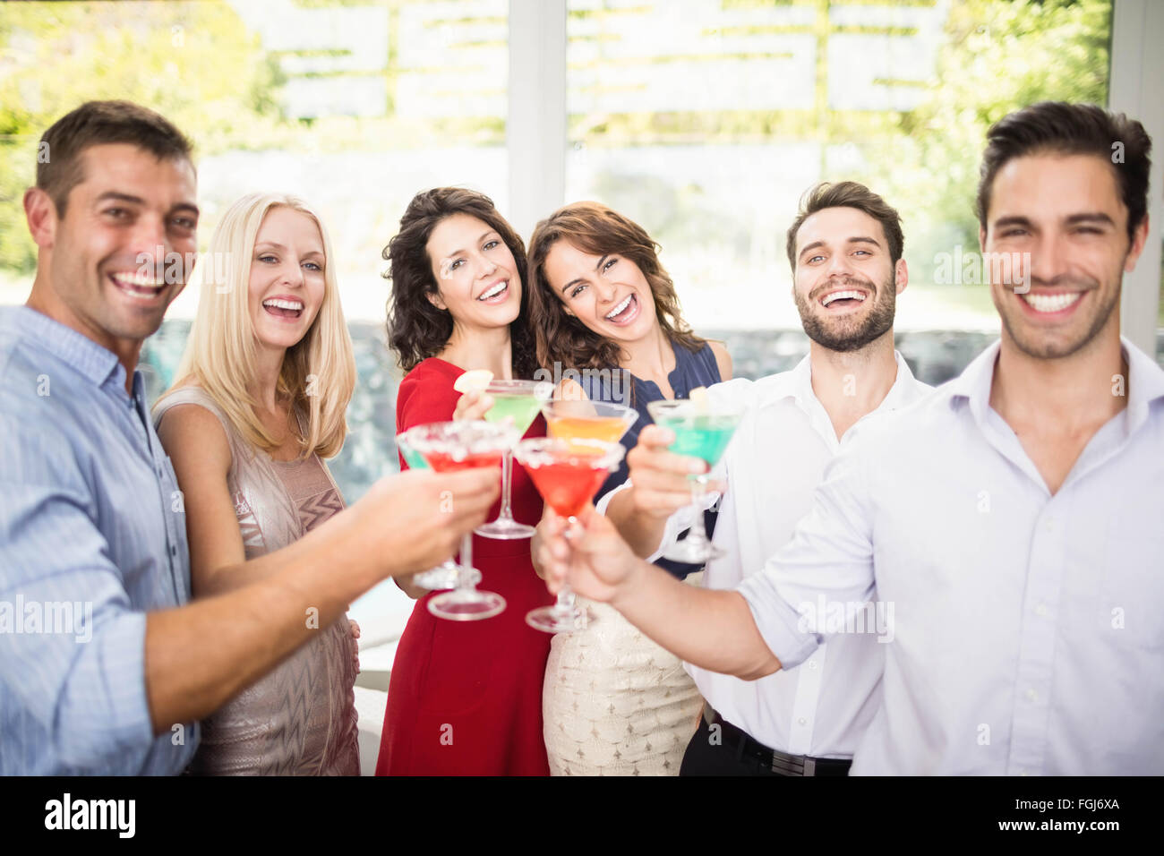 Group of friends having cocktail Stock Photo - Alamy