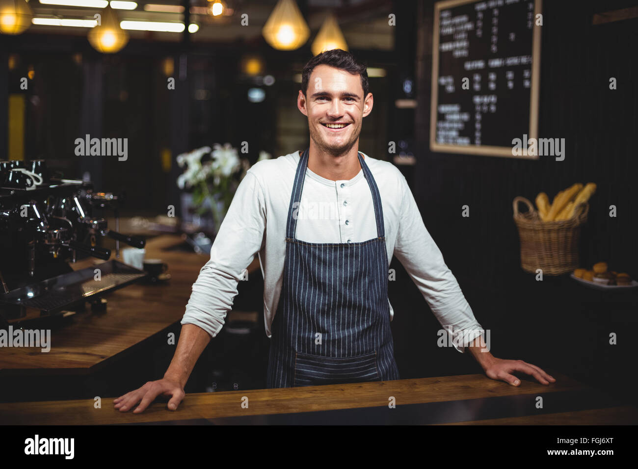 Smiling barista standing in the bar Stock Photo - Alamy