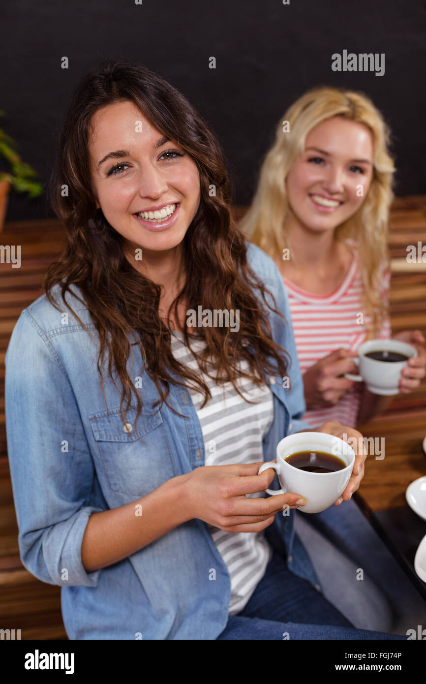 Smiling friends enjoying coffee together Stock Photo - Alamy