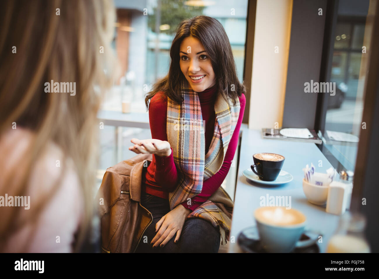 Pretty friends chatting over coffee Stock Photo - Alamy