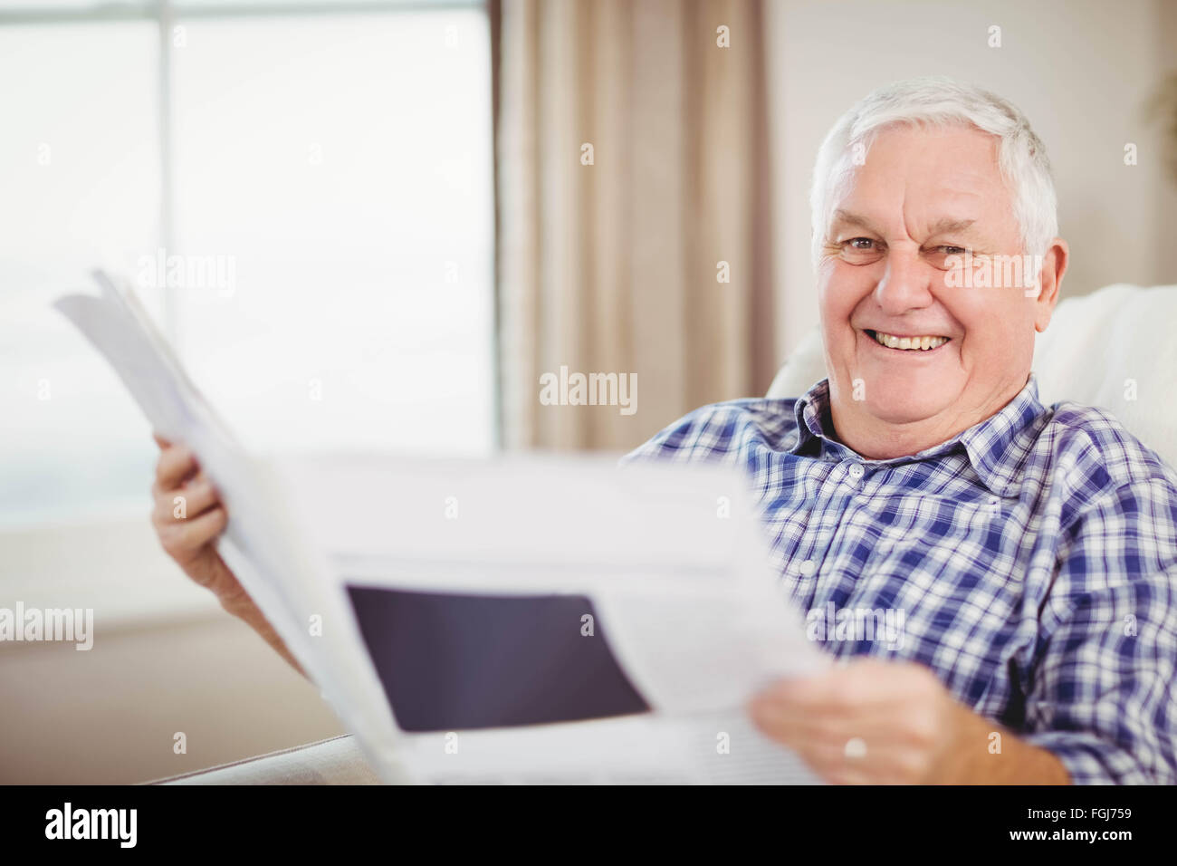 Senior man reading a newspaper Stock Photo - Alamy