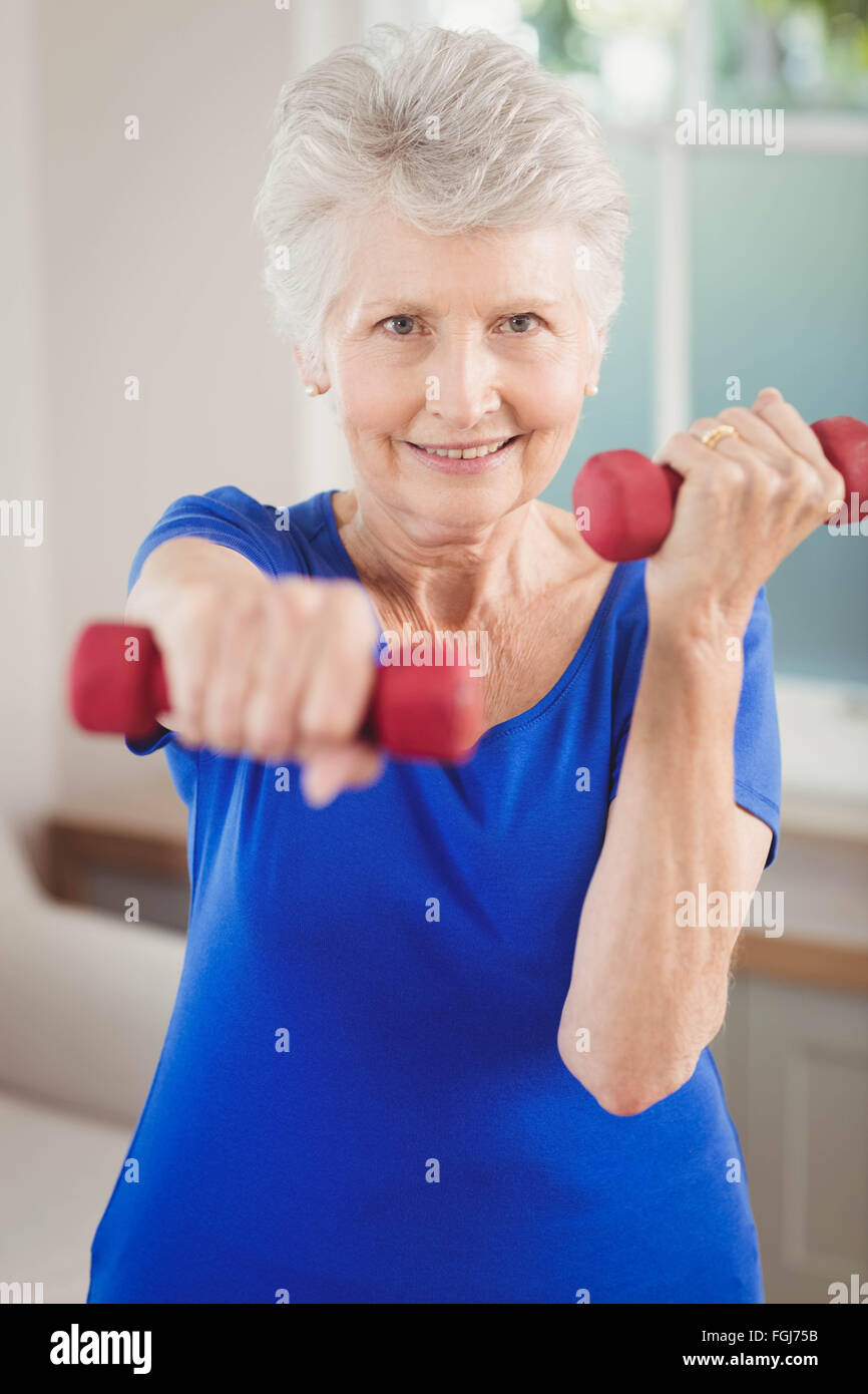 Portrait of senior woman exercising with dumbbells Stock Photo - Alamy