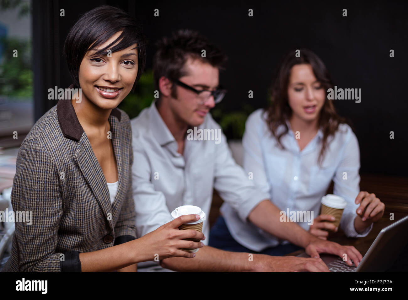Friends using laptop together Stock Photo - Alamy
