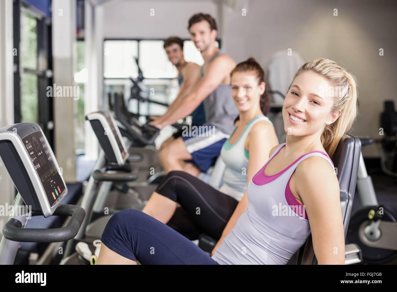Fit people doing exercise bike Stock Photo - Alamy