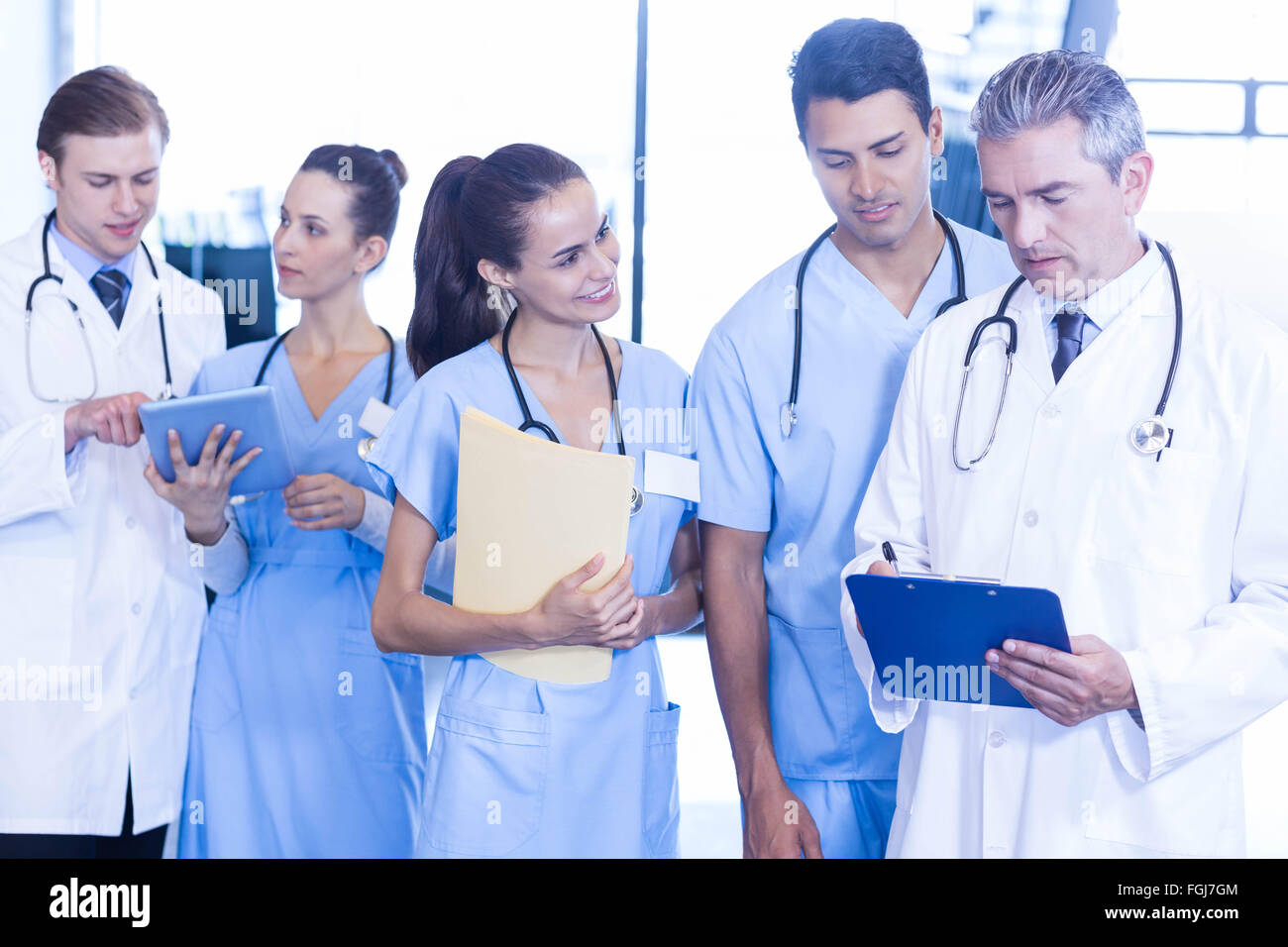 Doctors examining medical report Stock Photo - Alamy
